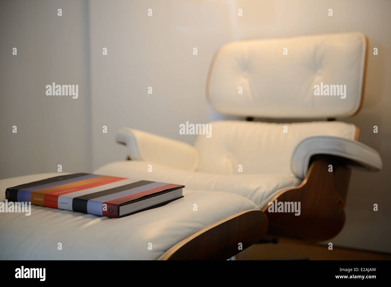 Reading corner with mid-century lounge chair and ottoman design by ...