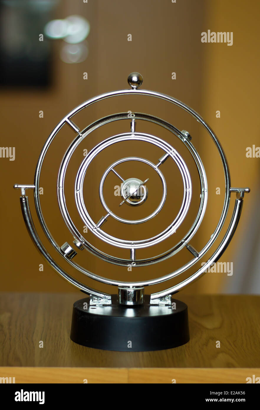swinging pendulum on the table in the room Stock Photo - Alamy