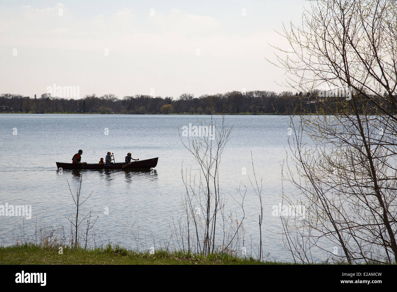 A Father and his three children in a canoe on Lake Calhoun, Minneapolis ...