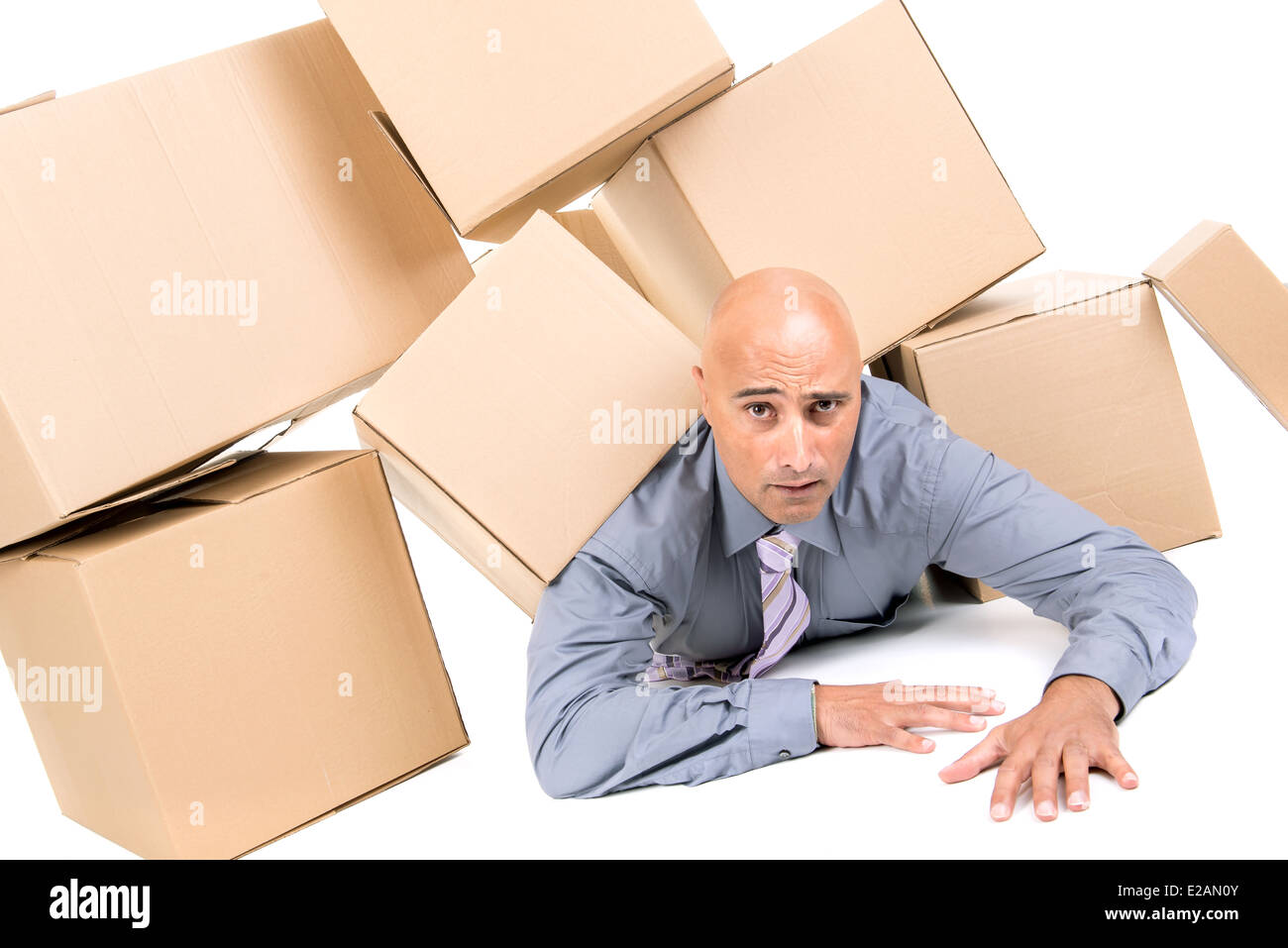 Stressed businessman under a pile of cardboard boxes Stock Photo - Alamy