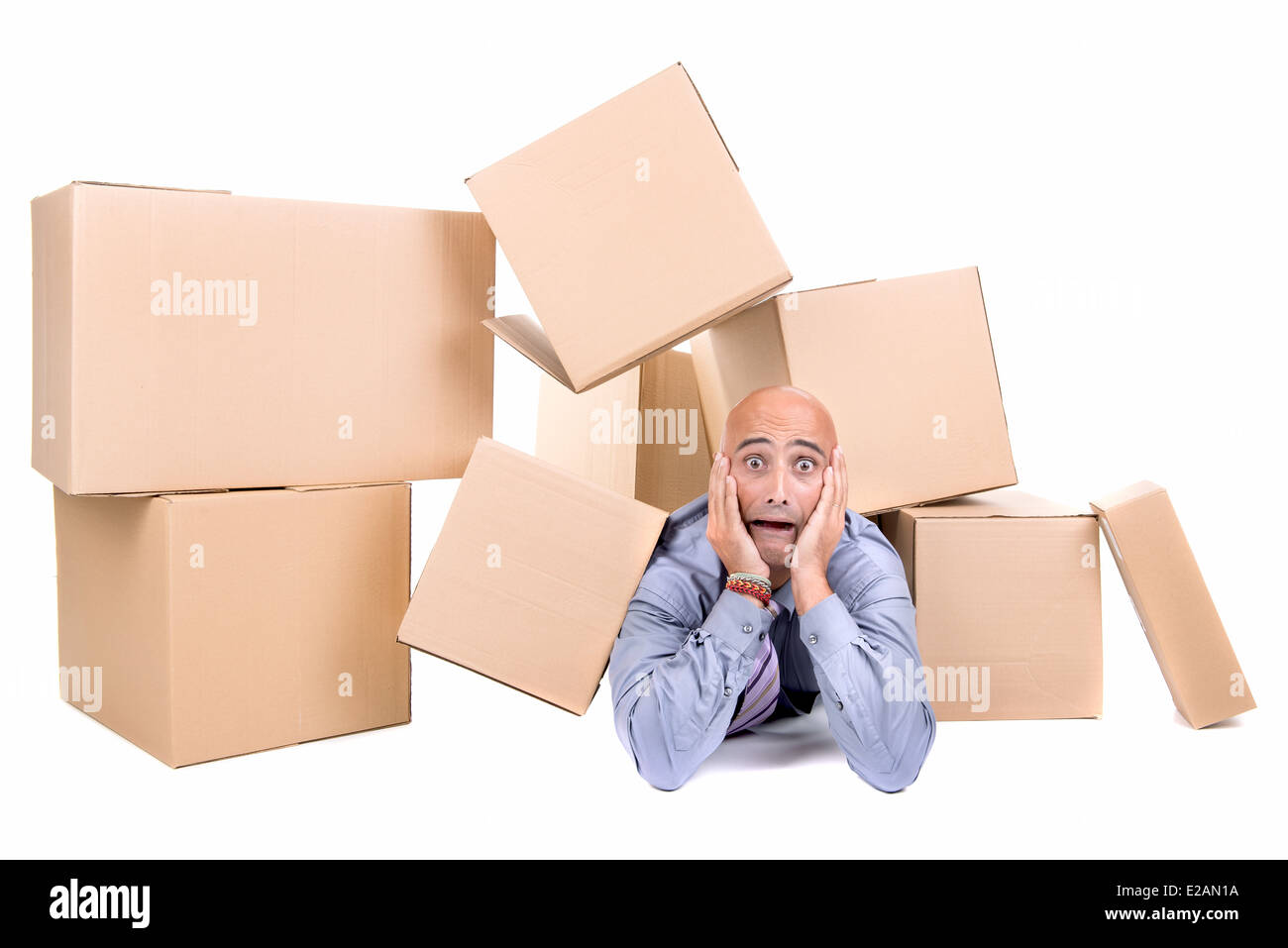 Stressed businessman under a pile of cardboard boxes Stock Photo - Alamy