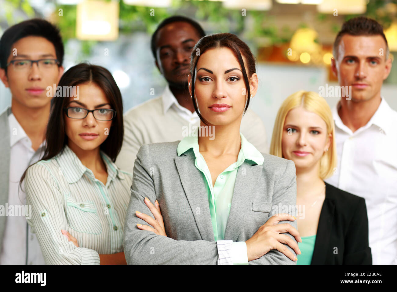 Group of co-workers standing in office Stock Photo - Alamy