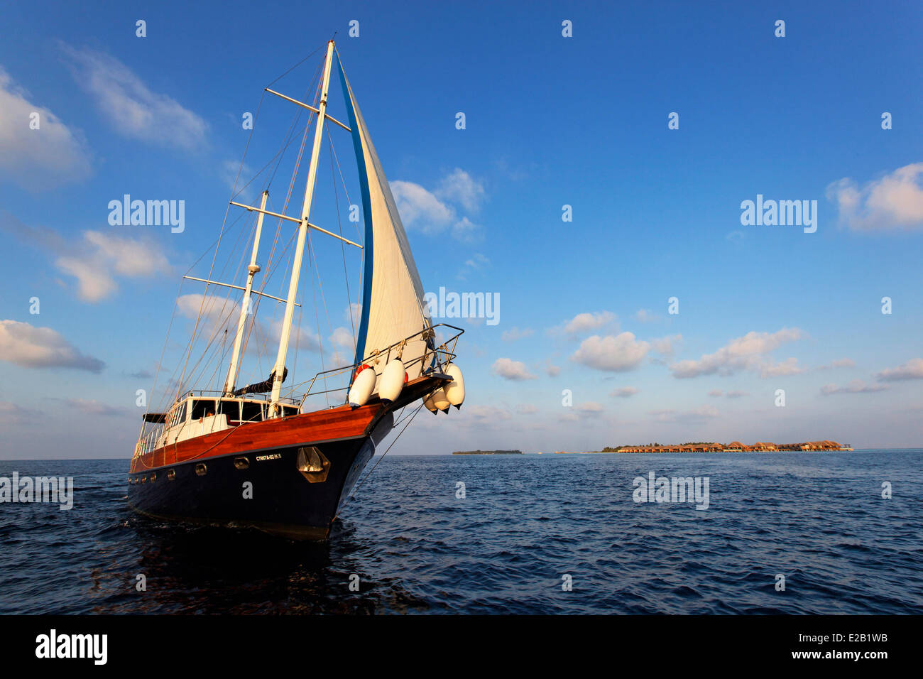 Maldives, Atoll Baa, Anantara Kihavah Villas hotel, boat at sunrise ...