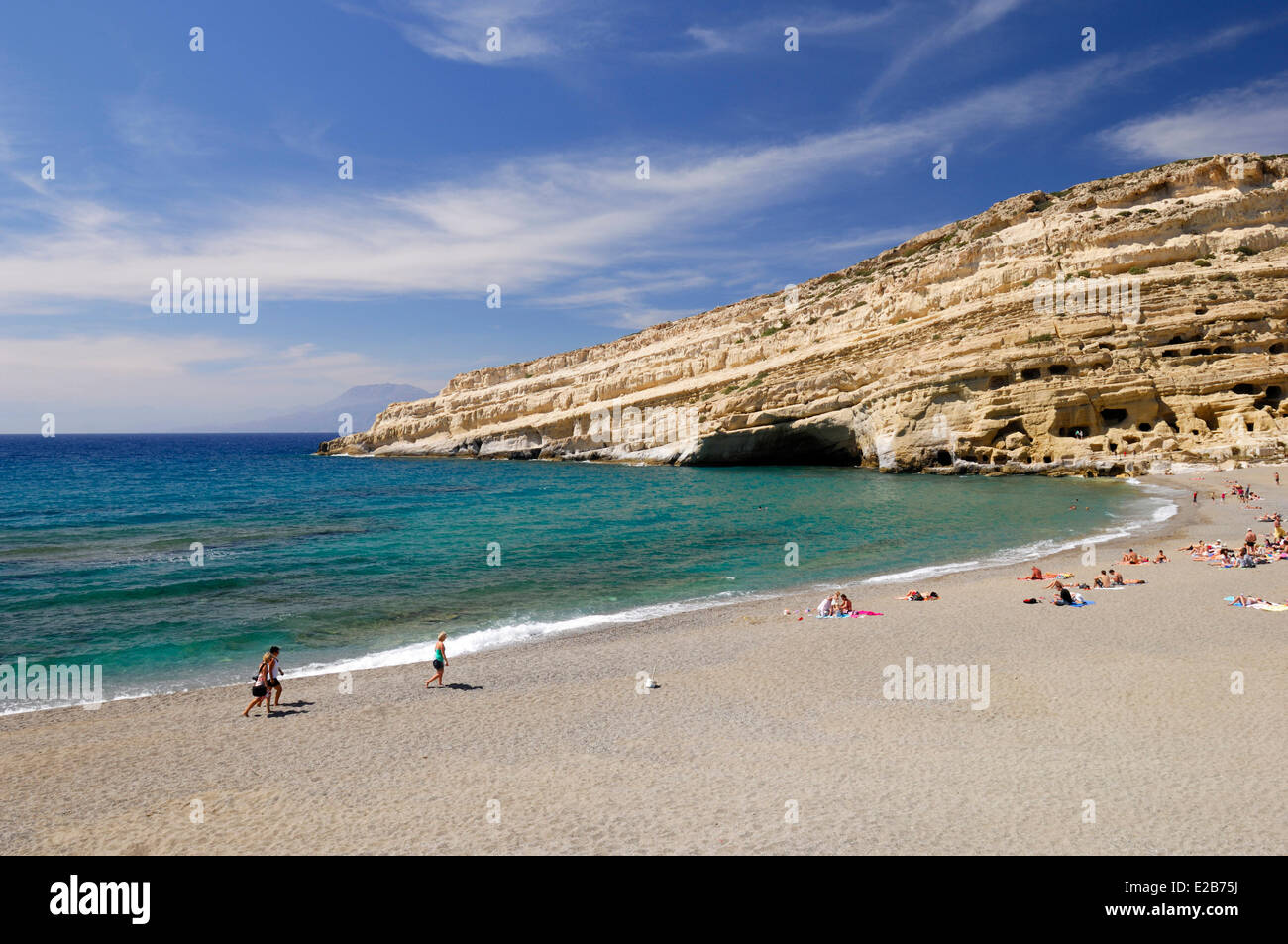 Greece, Crete, Matala, cliff bordering the sandy beach and diving into ...
