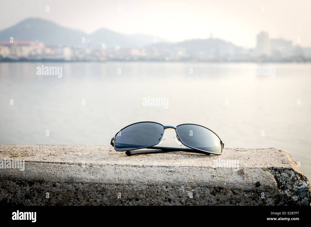 Sunlass and lake side city background Stock Photo - Alamy