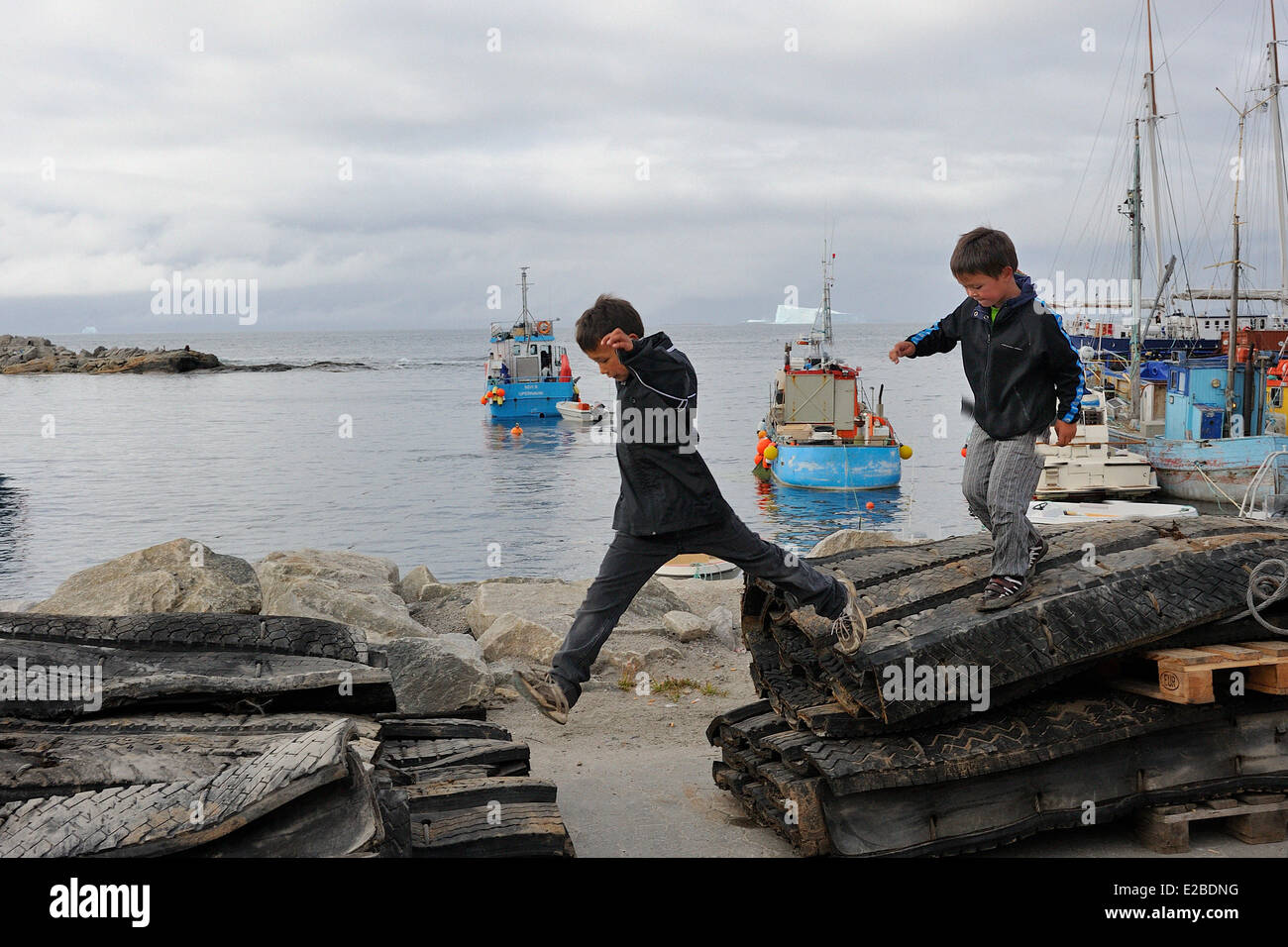 Greenland, Upernavik, The harbour, Inuit children at play Stock Photo ...