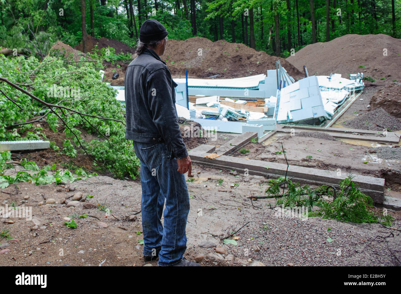 Essa, CAN., 17 Jun 2014 - An Angus area resident checks on the damage ...