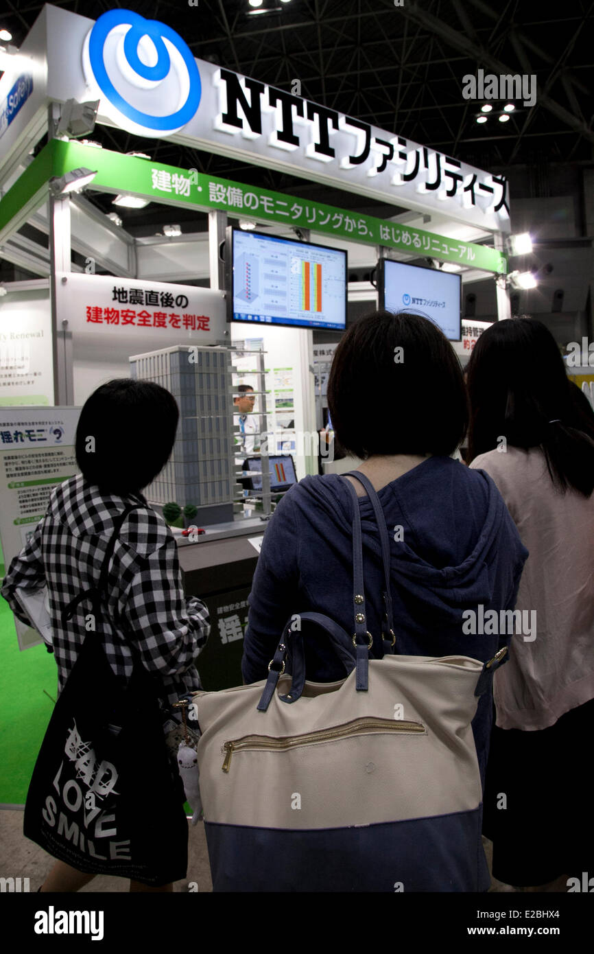 Tokyo, Japan 18th June, 2014. Visitors see the NTT building monitor at ...