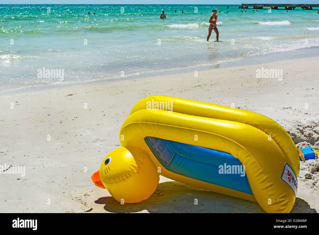 An inflatable duck beach float lies abandoned on the beach near the ...