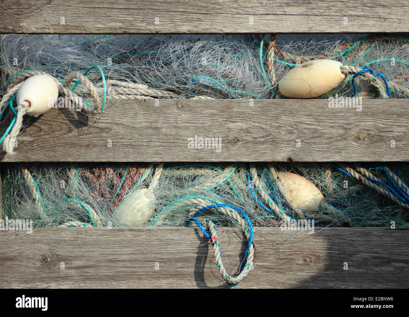 Blue industry fishing nets in old wooden storage box Stock Photo - Alamy