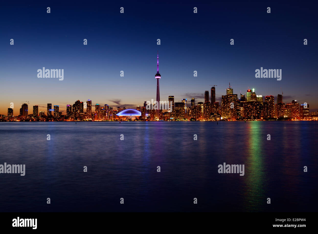 Toronto city skyline at dusk on a clear blue night with reflections in ...