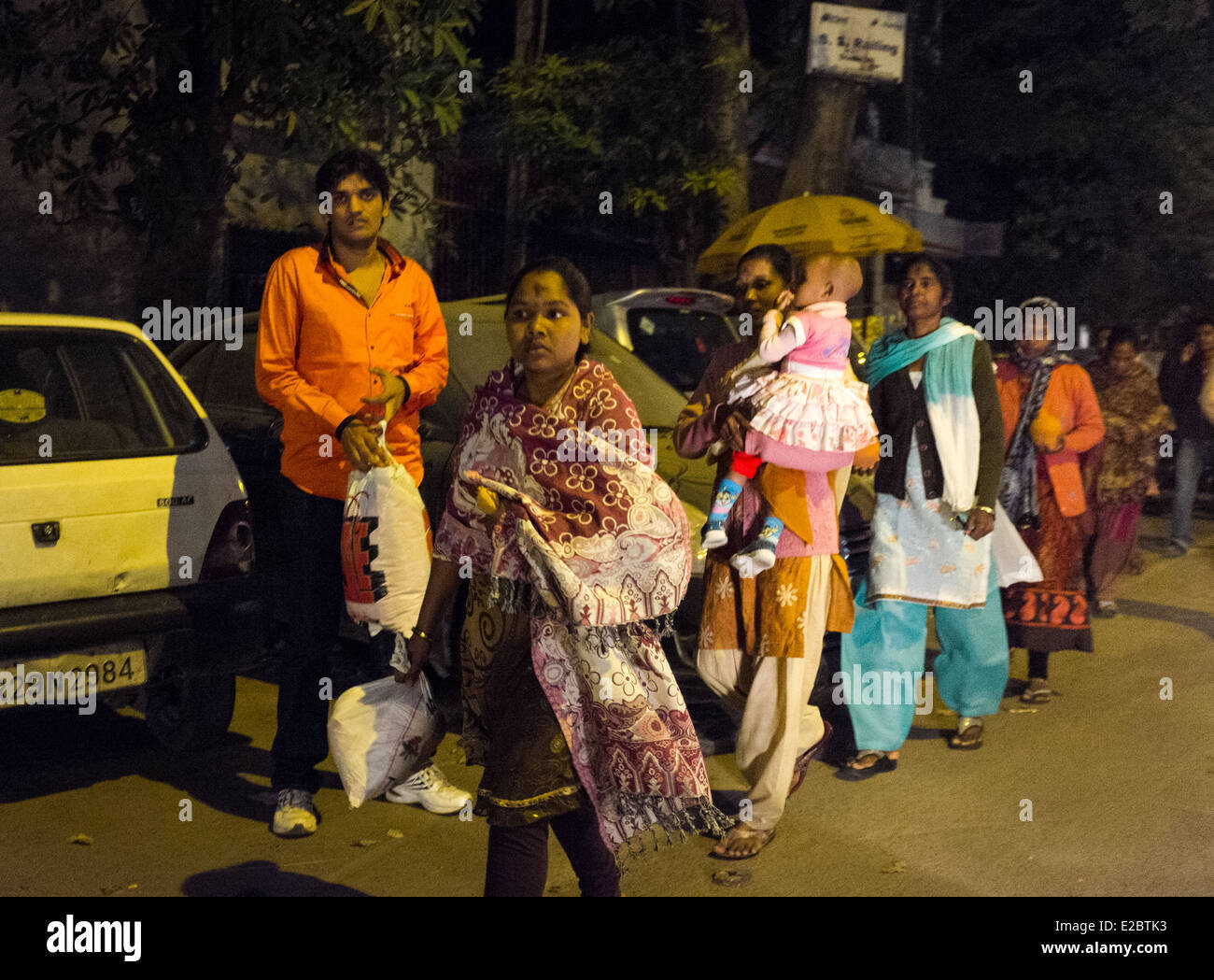 An Indian family walks along a congested roadway in New Delhi, India ...