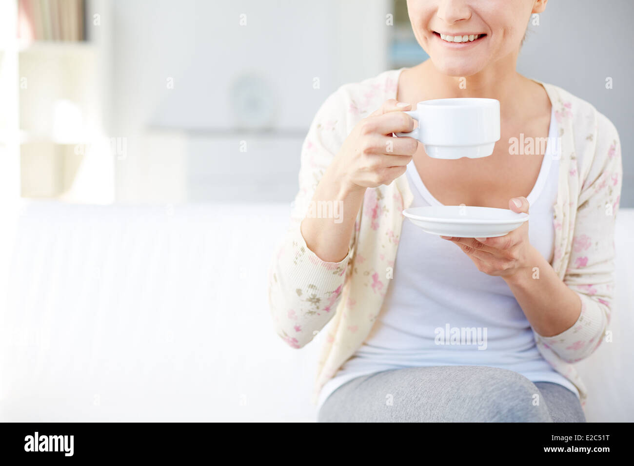 Image of young smiling woman drinking tea Stock Photo - Alamy
