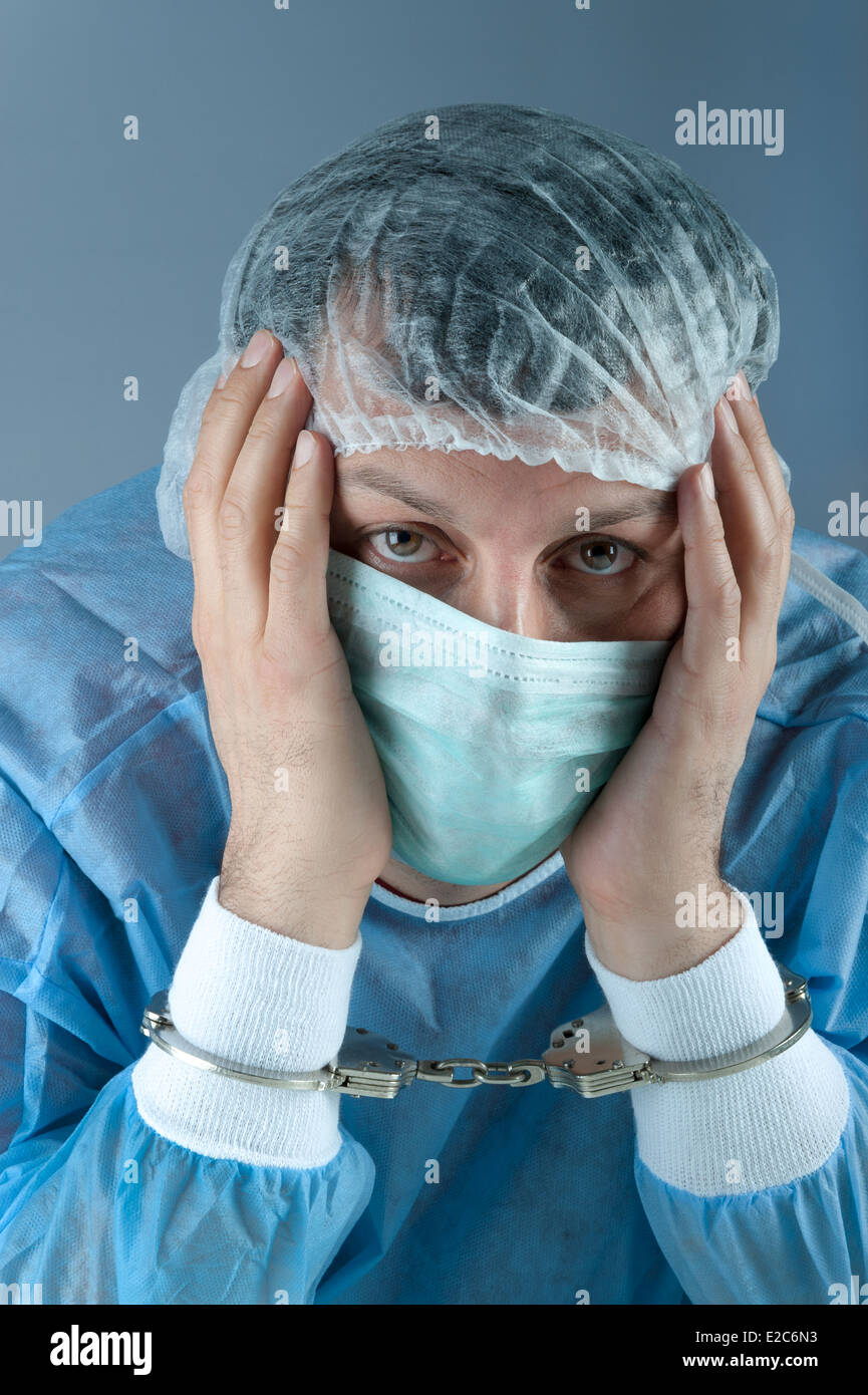 Isolated regretful criminal handcuffed surgeon portrait on white ...