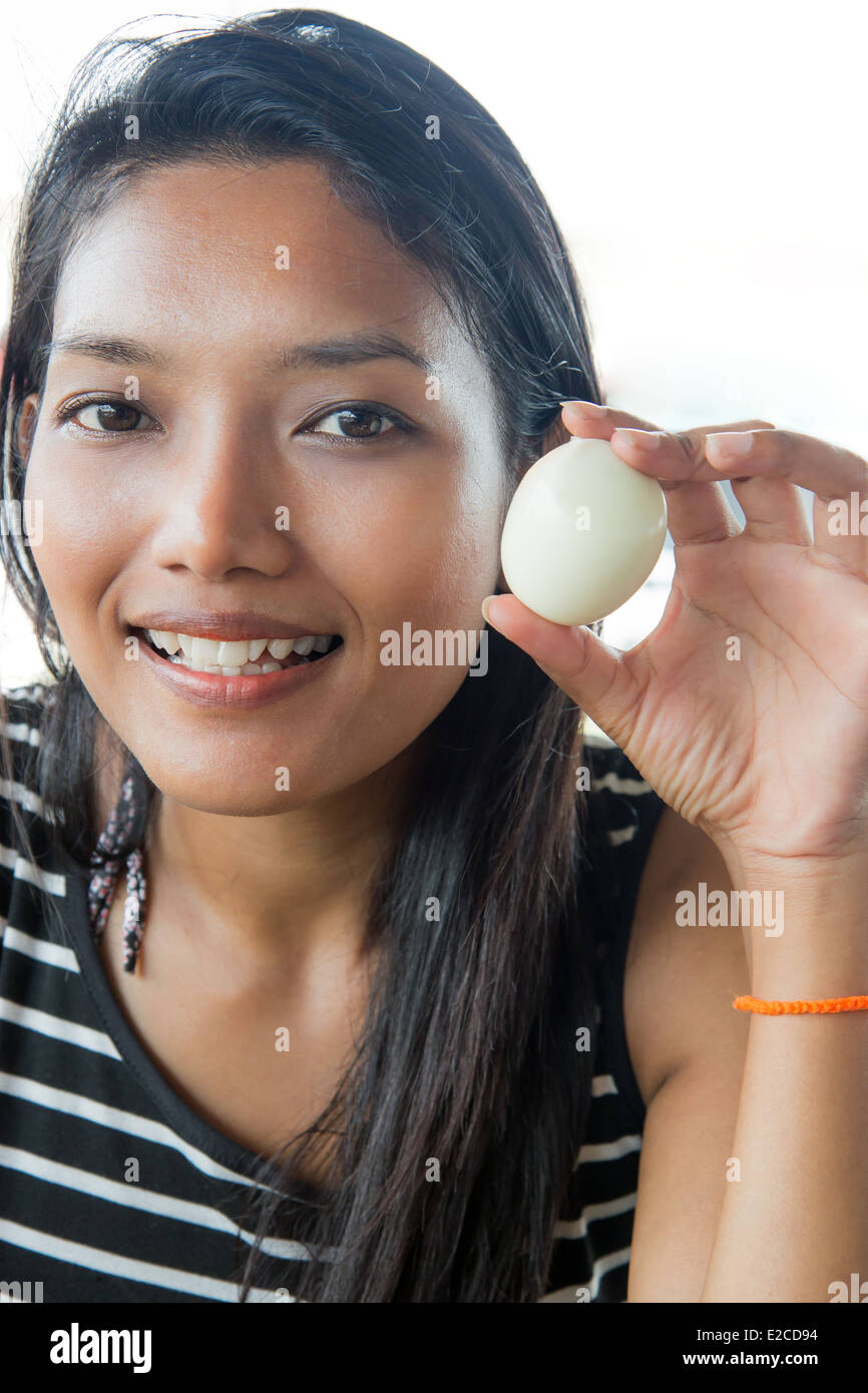 young happy woman showing a peeled egg Stock Photo - Alamy