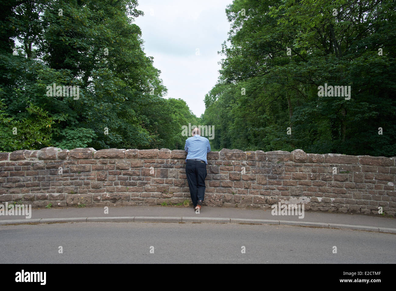 man looking over a railway bridge Stock Photo - Alamy