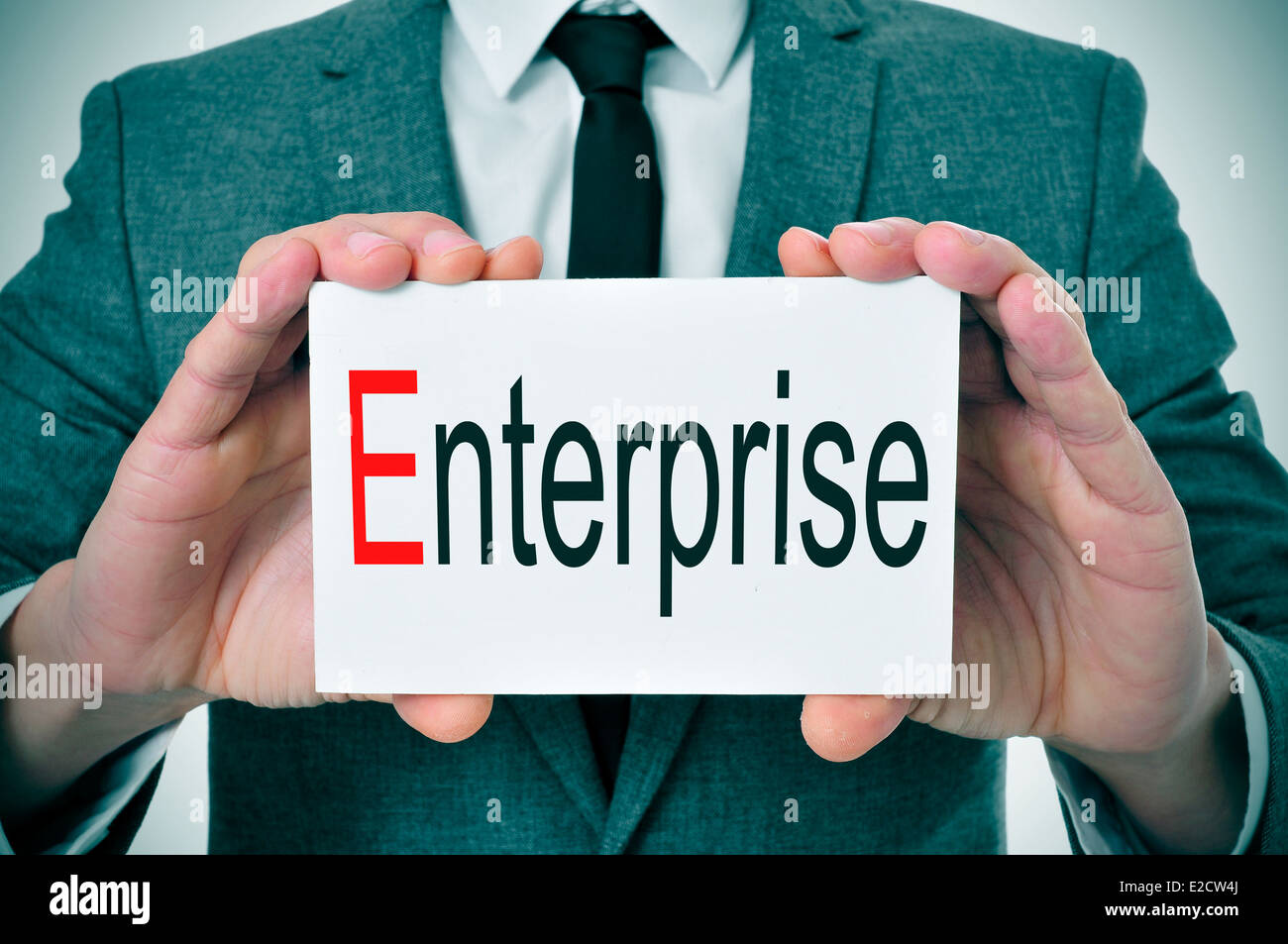 a man wearing a suit showing a signboard with the word enterprise ...
