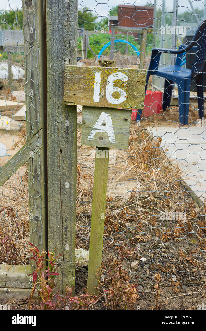 Wooden sign giving garden plot number Stock Photo - Alamy