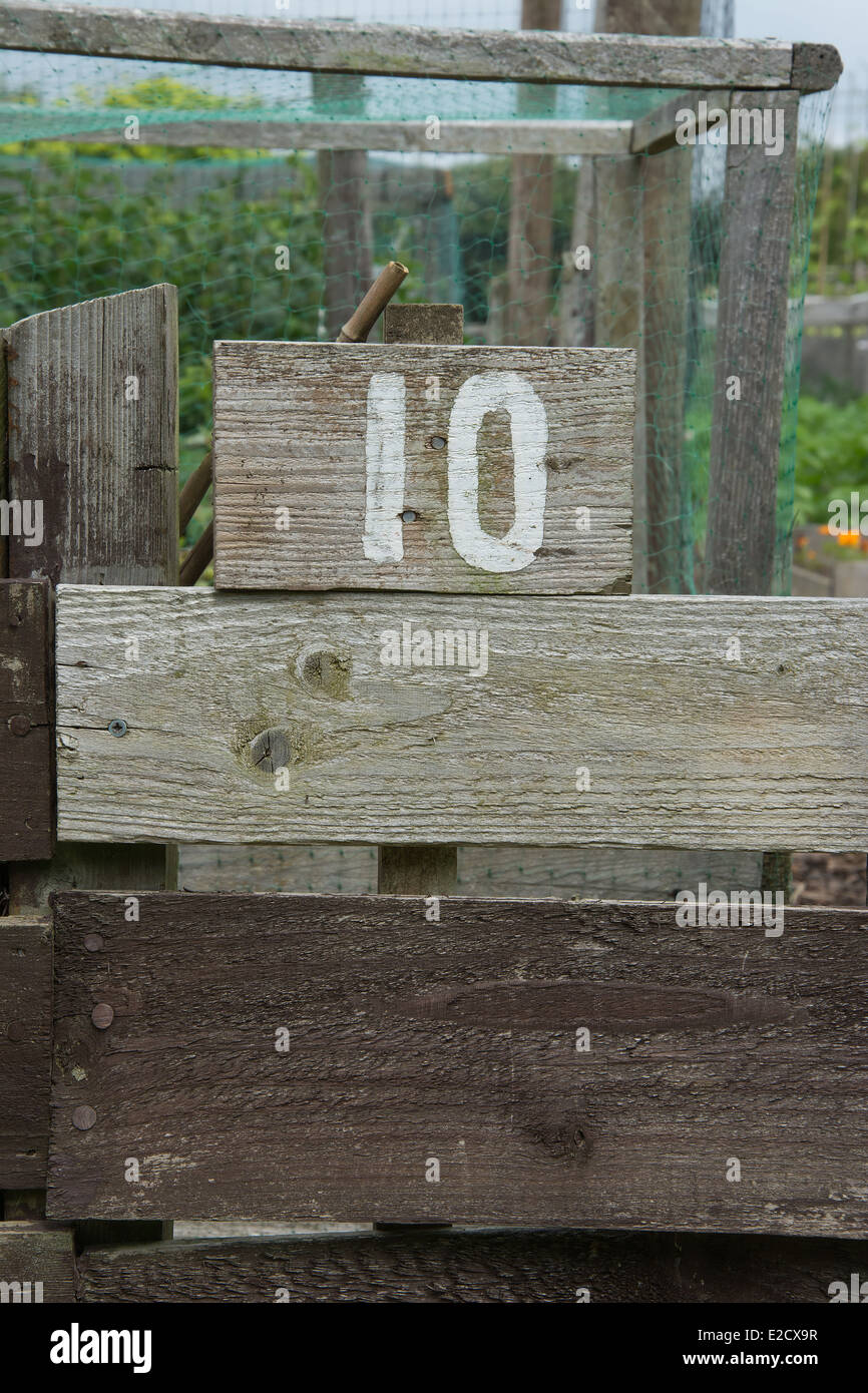 Wooden sign giving garden plot number Stock Photo - Alamy