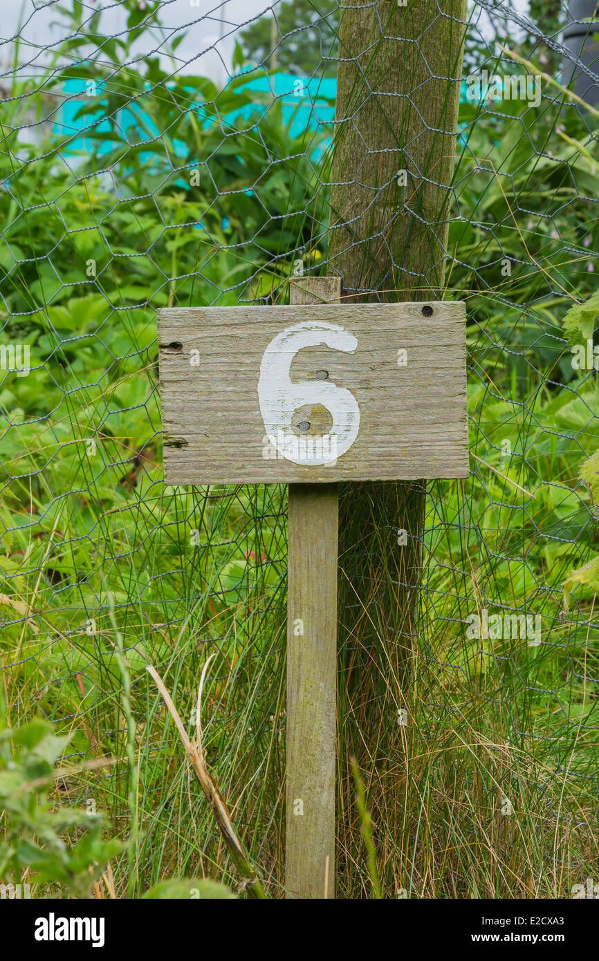 Wooden sign giving garden plot number Stock Photo - Alamy