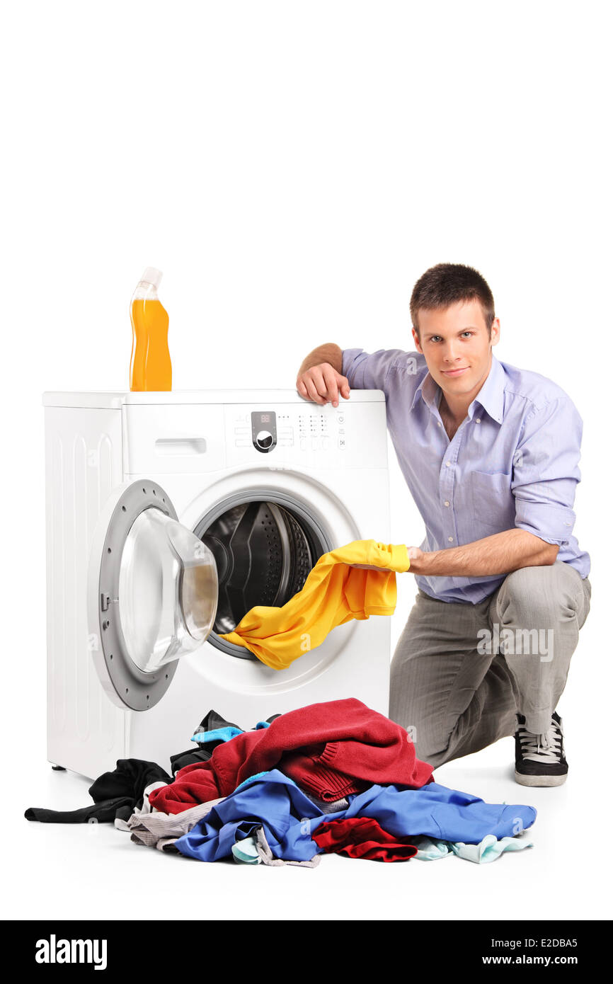 Young man doing laundry isolated on white background Stock Photo - Alamy
