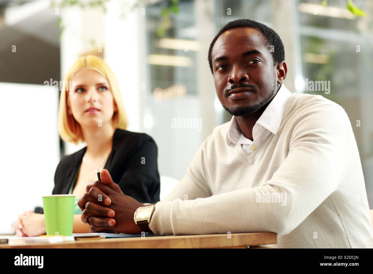 Business people sitting around a table during a meeting in office Stock ...