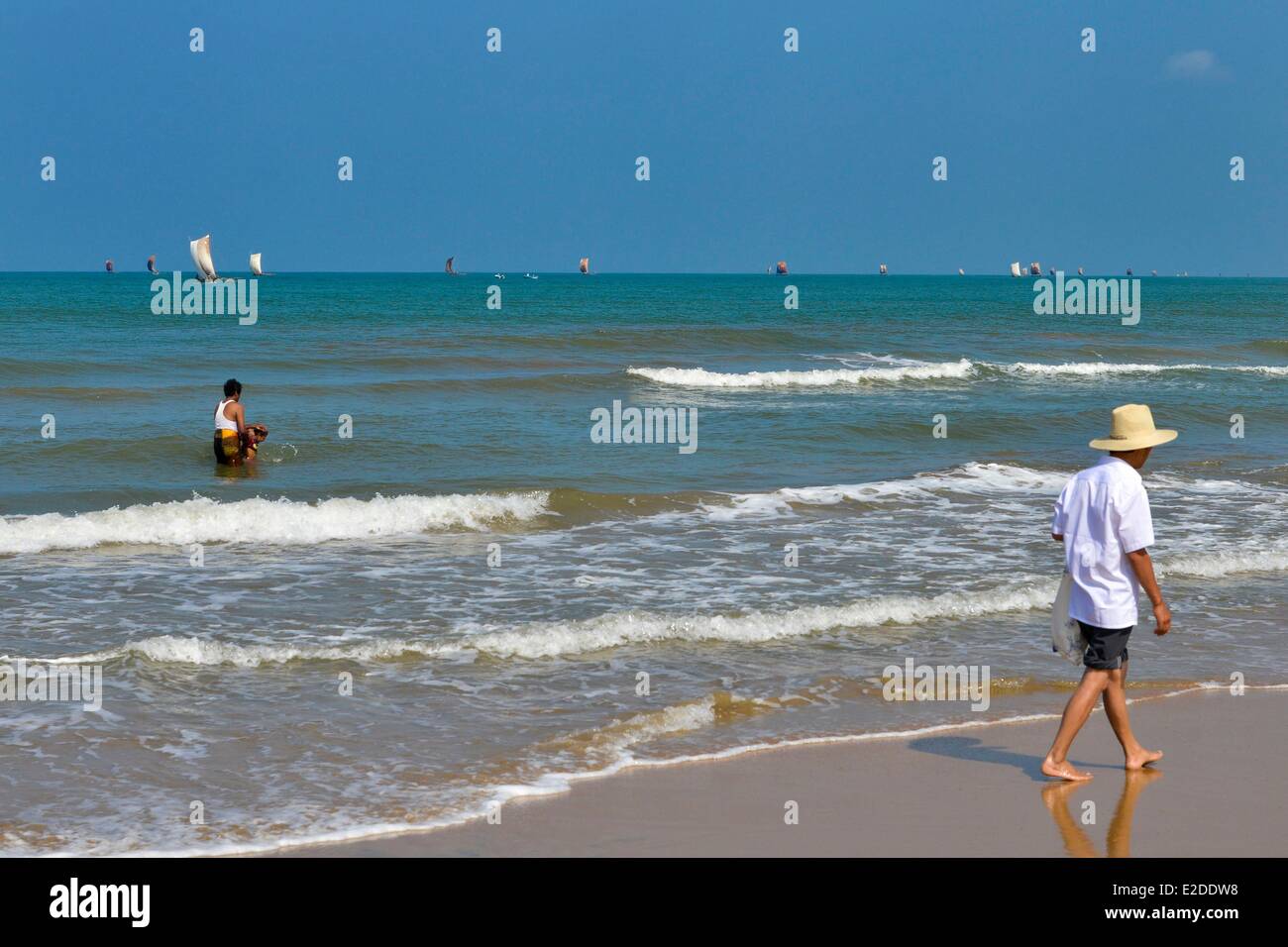 Sri Lanka Western Province Gampaha District Negombo Walker with a hat on a beach with sailboats ...