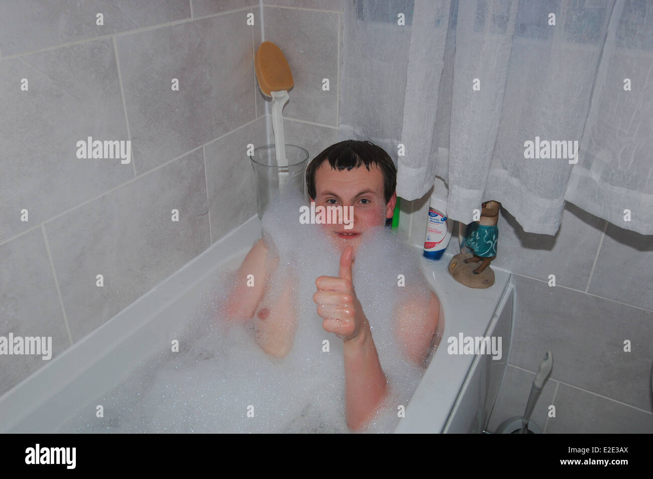 Teenage Man Having A Bath Stock Photo - Alamy