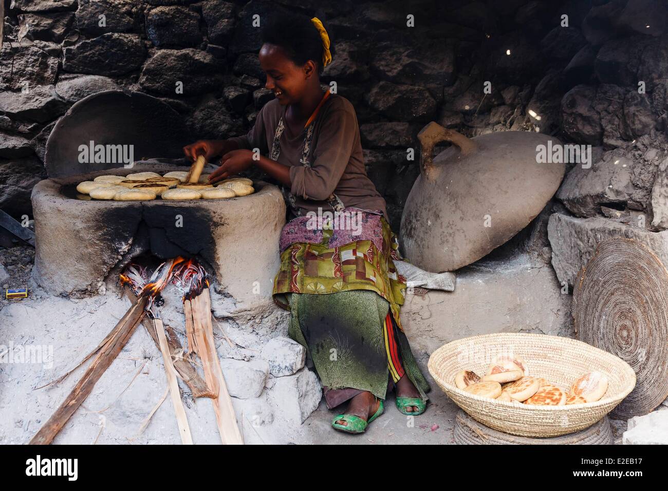 Ethiopia, Tigray region, Maychew, young lady cooking bread in a wood ...