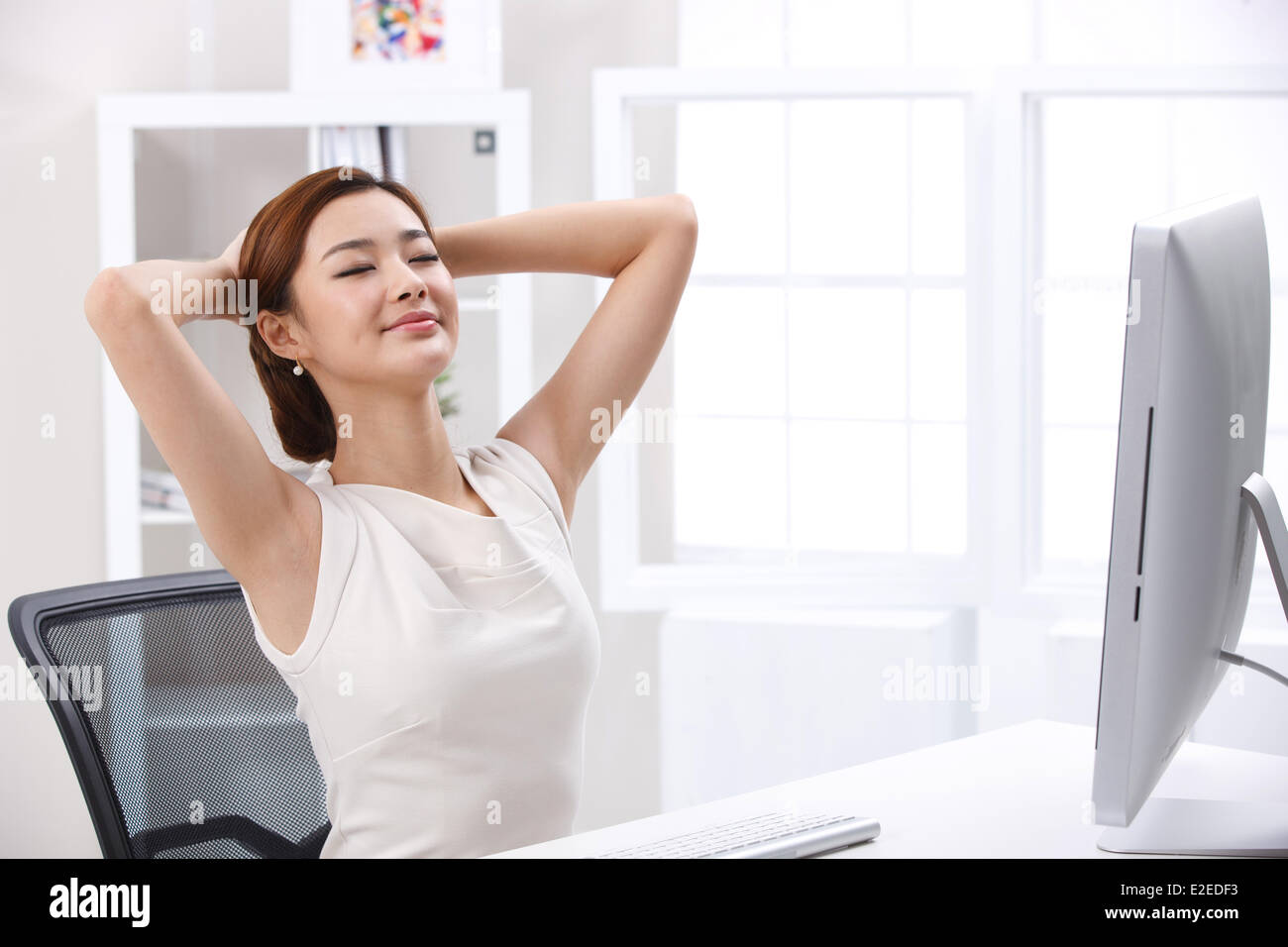 Young business lady sitting in front of computer Stock Photo - Alamy