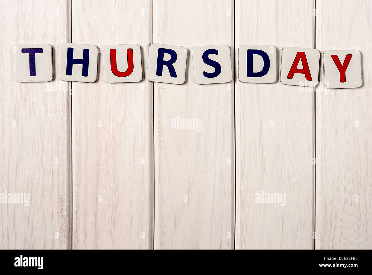 Inscription on Thursday against a white wood texture Stock Photo - Alamy