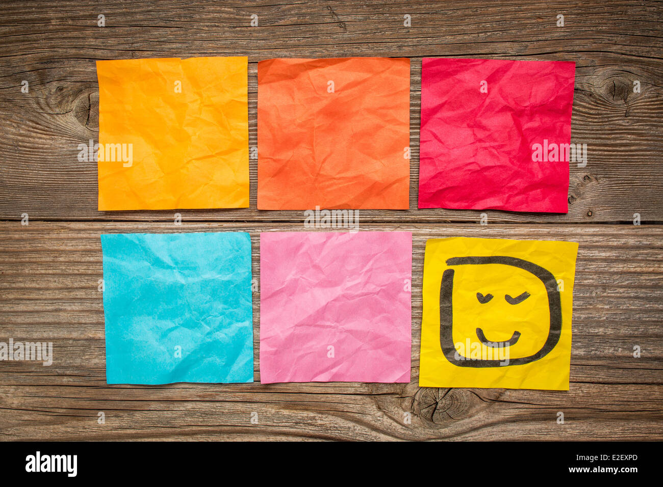 colorful blank sticky notes with smiley against grained wood Stock ...