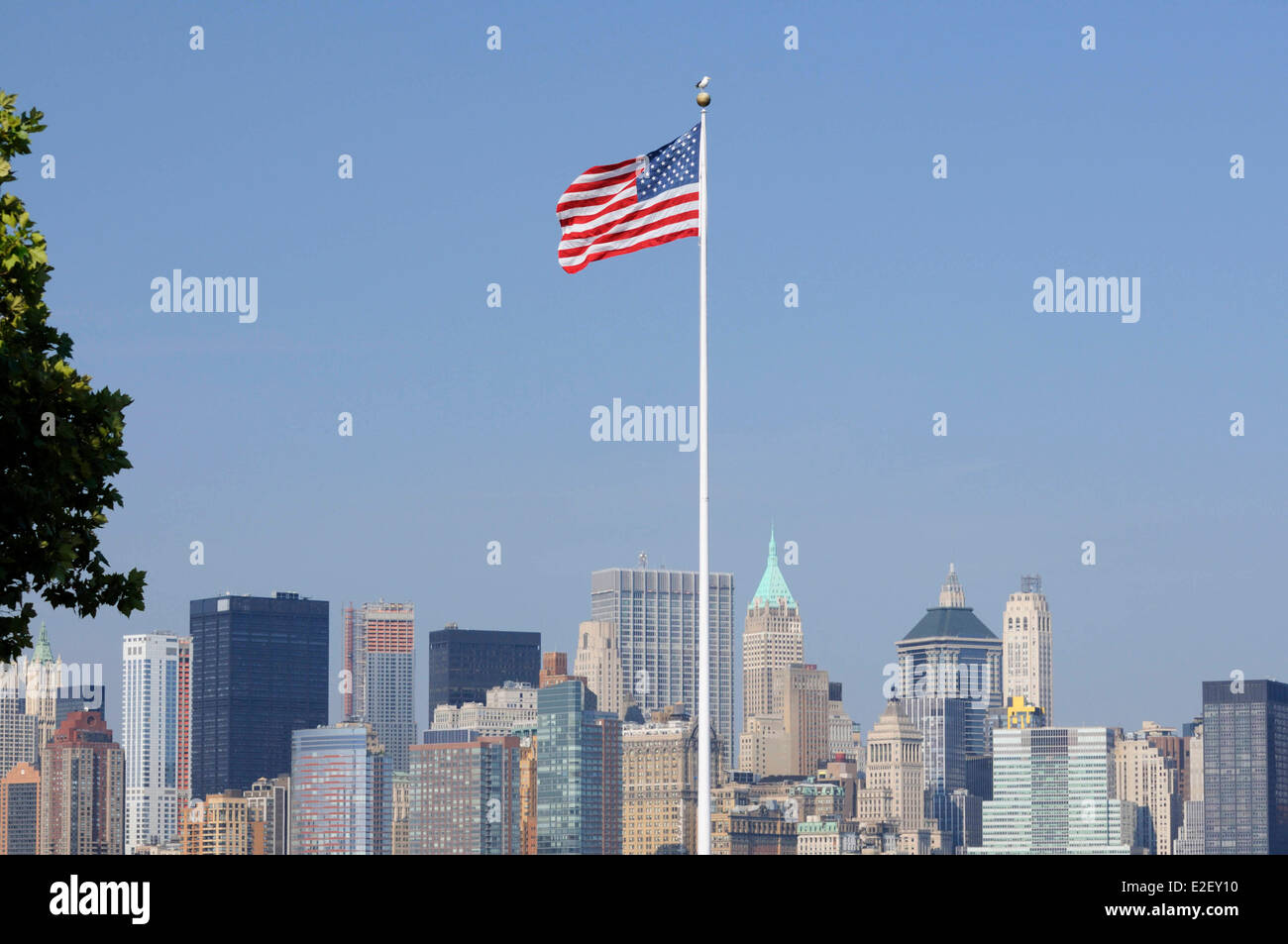 United States, New York, American flag on Ellis Island and Manhattan ...