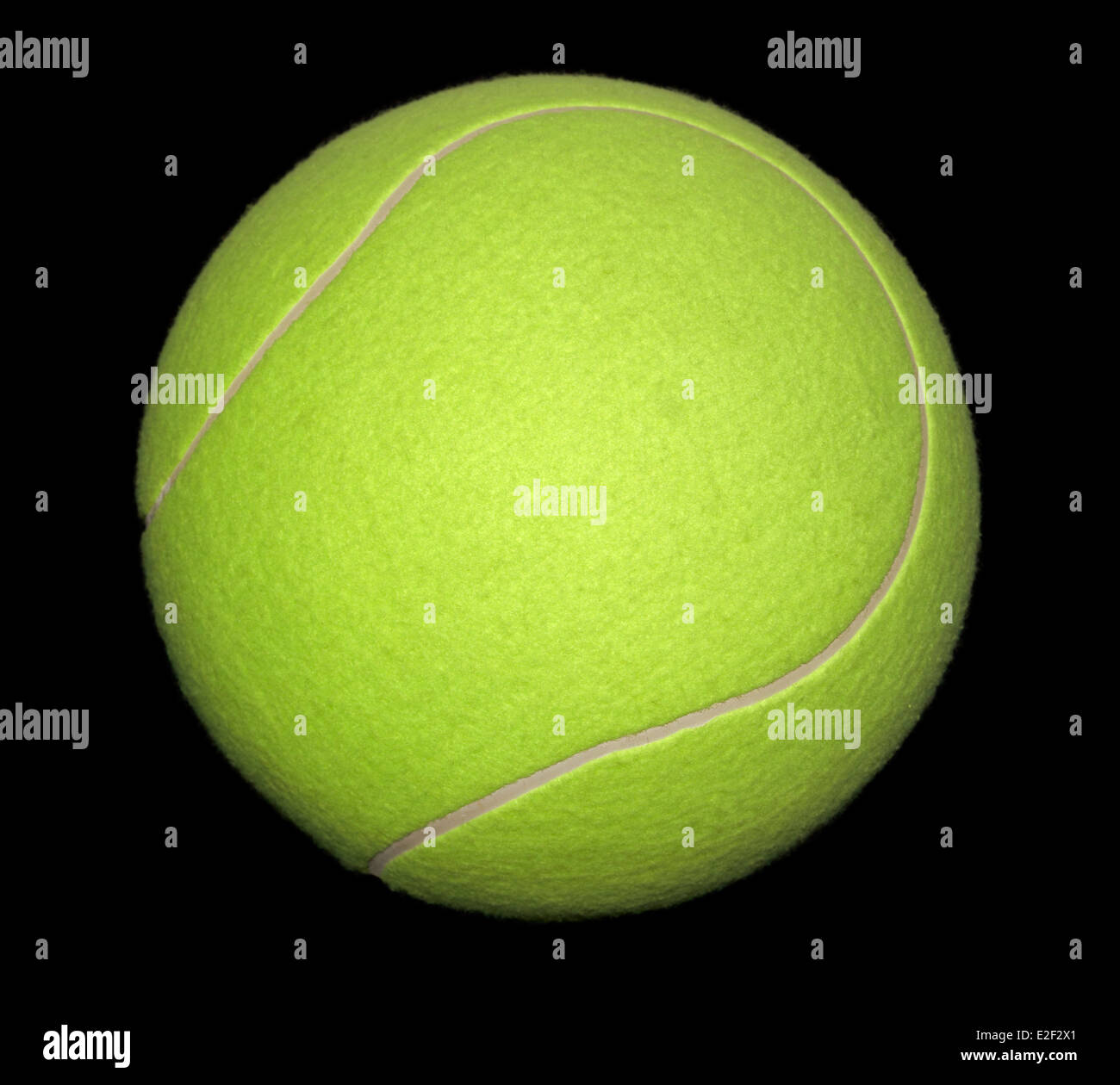 a yellow tennis ball in black back Stock Photo - Alamy