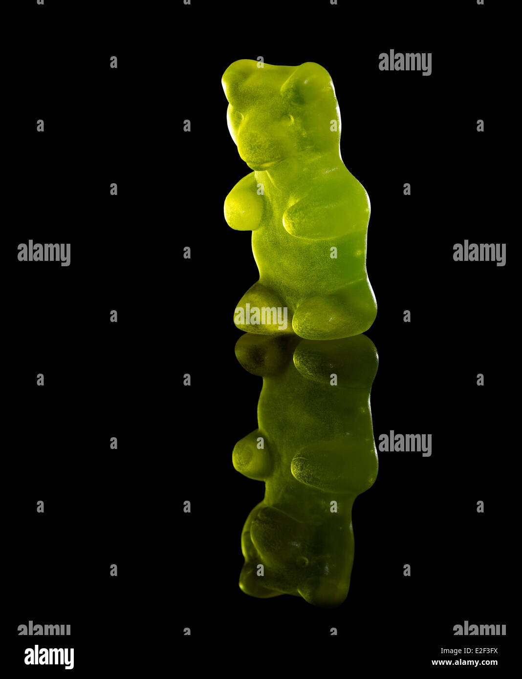 green translucent gummy bear in black reflective back Stock Photo - Alamy