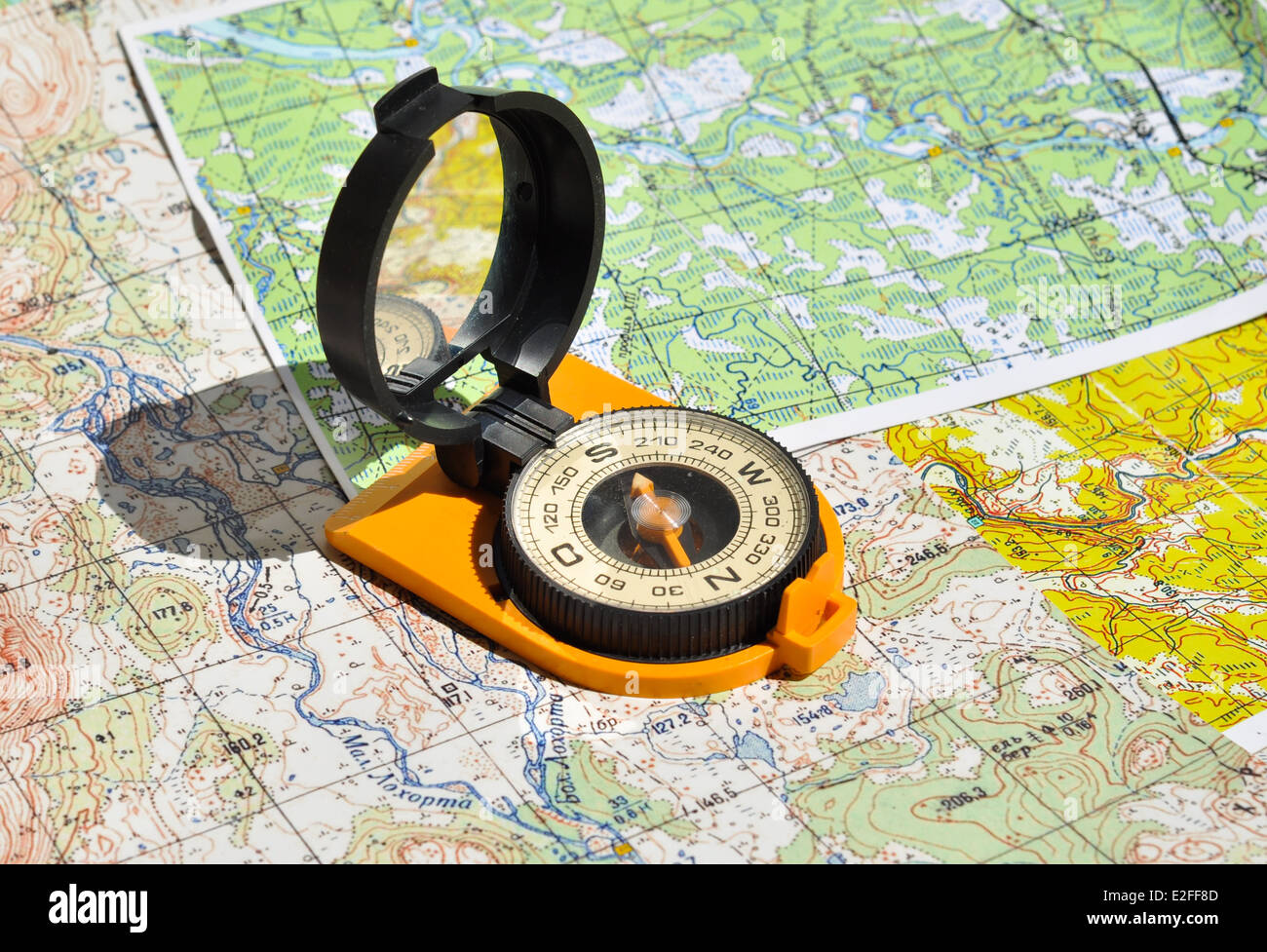 Compass lies on a topographic map. Compass on the map - this is the ...