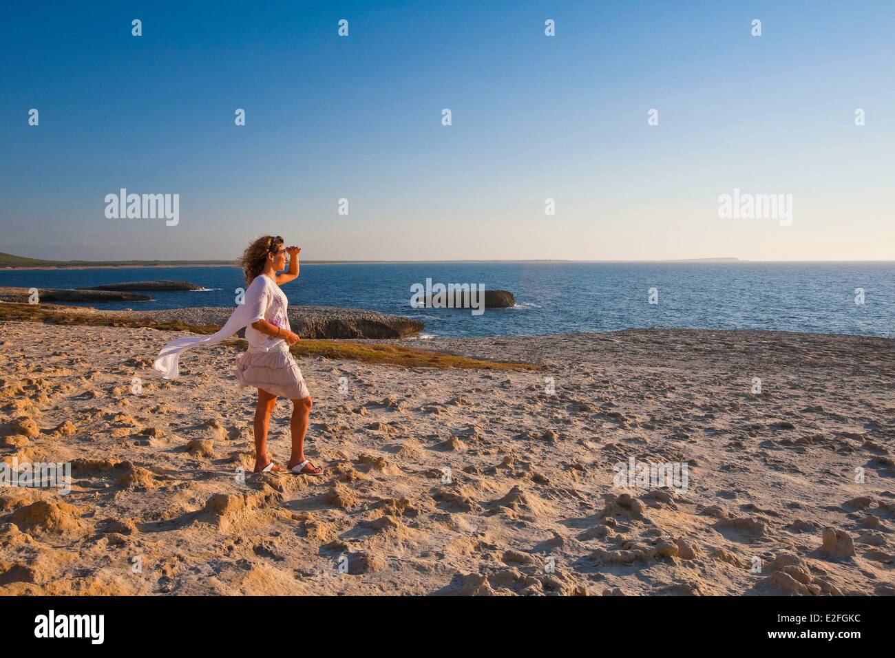 Italy, Sardinia, Oristano province, S'Archittu woman walking on the ...