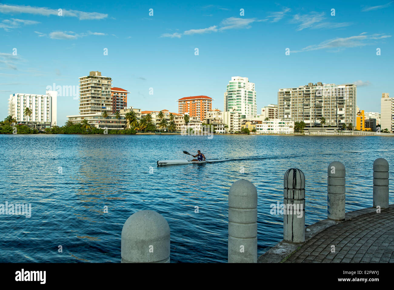 Kayaker on El Condado Lagoon and skyline, El Condado, San Juan, Puerto ...