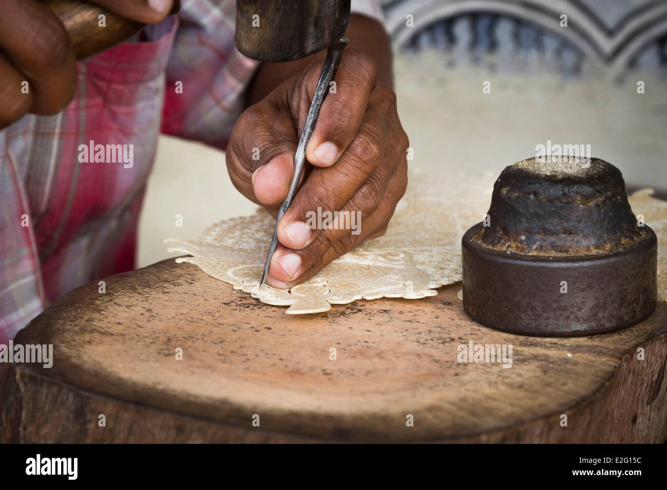 Indonesia Java Yogyakarta craftsman at work carving a figure into ...