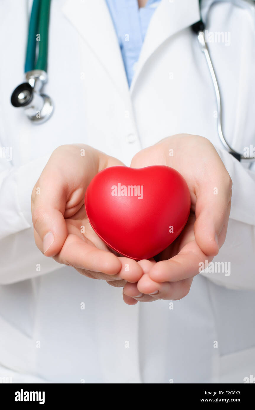 Doctor holding a red heart shape Stock Photo - Alamy