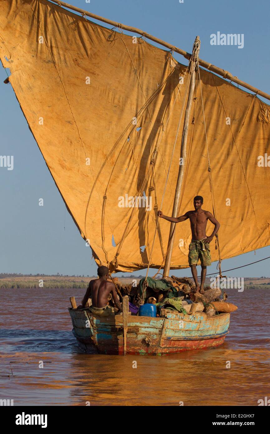 Madagascar Mahajunga Bombetoka Traditional boat carrying wood logs ...