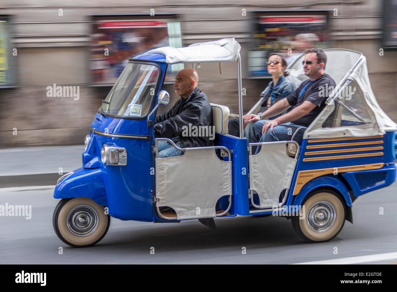 Italy Lazio Rome visiting city on a Vespa three-wheeled convertible ...
