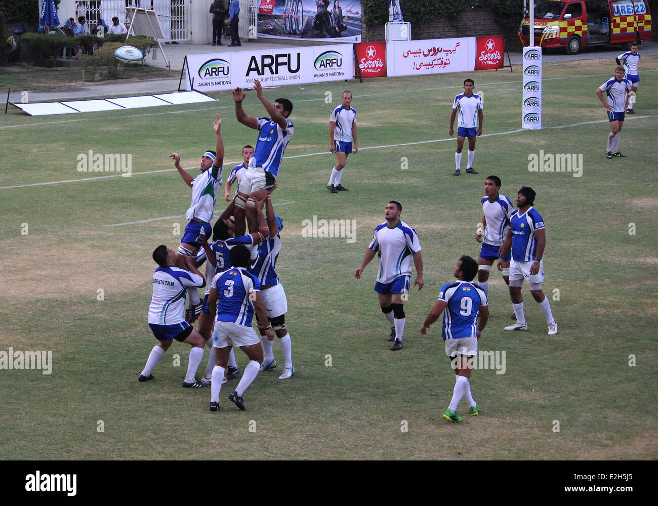 Indian rugby players (blue shirt) fight for the ball with Uzbekistan ...