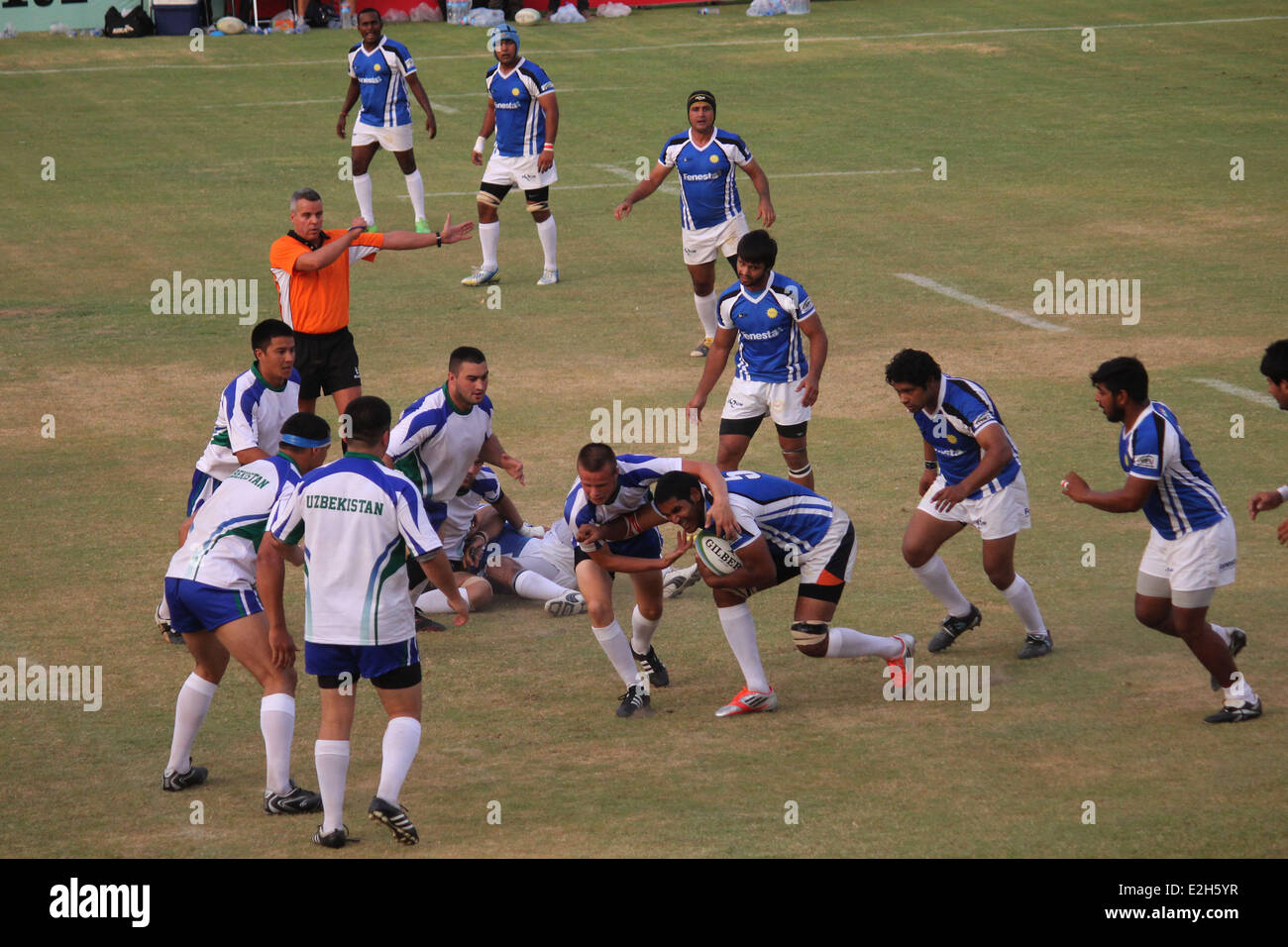Indian rugby players (blue shirt) fight for the ball with Uzbekistan ...