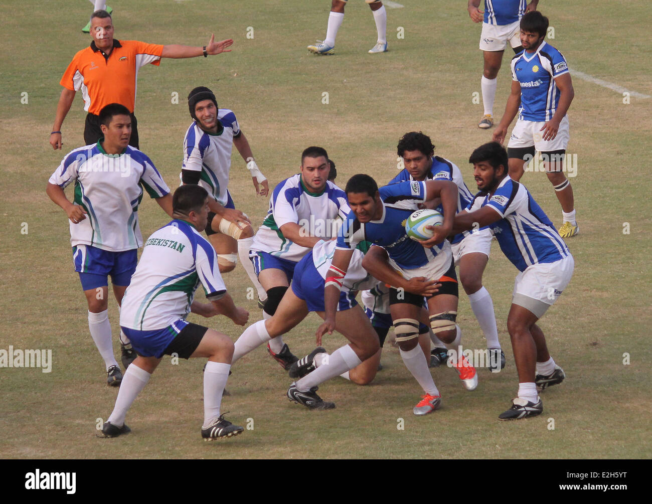 Indian rugby players (blue shirt) fight for the ball with Uzbekistan ...