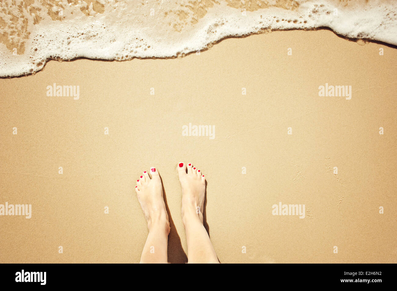top down view of feet waiting for a wave to come in, oh the ...