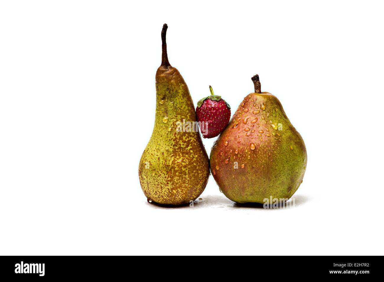 Two pear fruits and one strawberry between them Stock Photo - Alamy