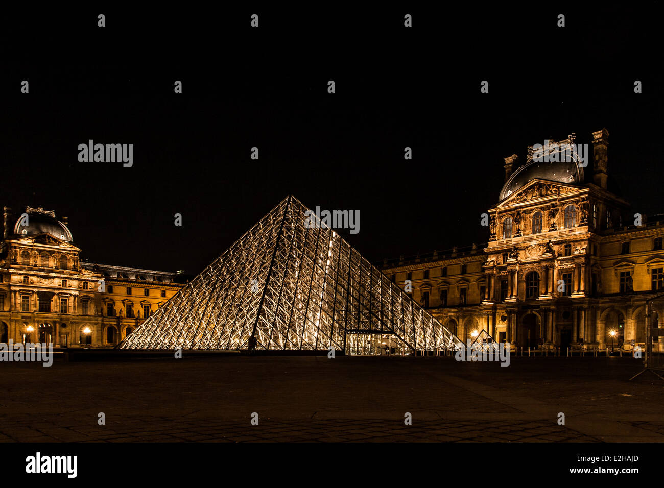 The Louvre Pyramid, a large glass and metal pyramid structure in the ...