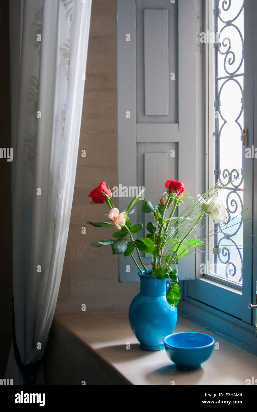 Roses in a blue vase at Riad Ksar Anika in Marrakesh, Morocco, North ...