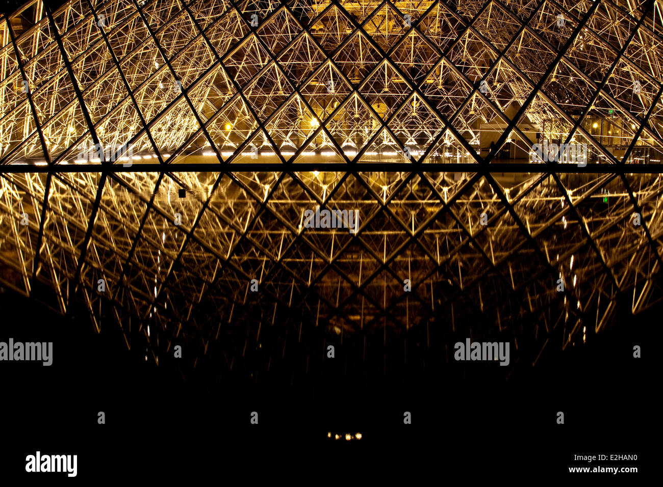 The Louvre Pyramid, a large glass and metal pyramid structure in the ...